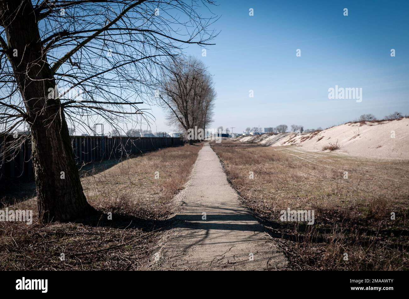A straight concrete pathway in inhospitable environment symbolizing the ...