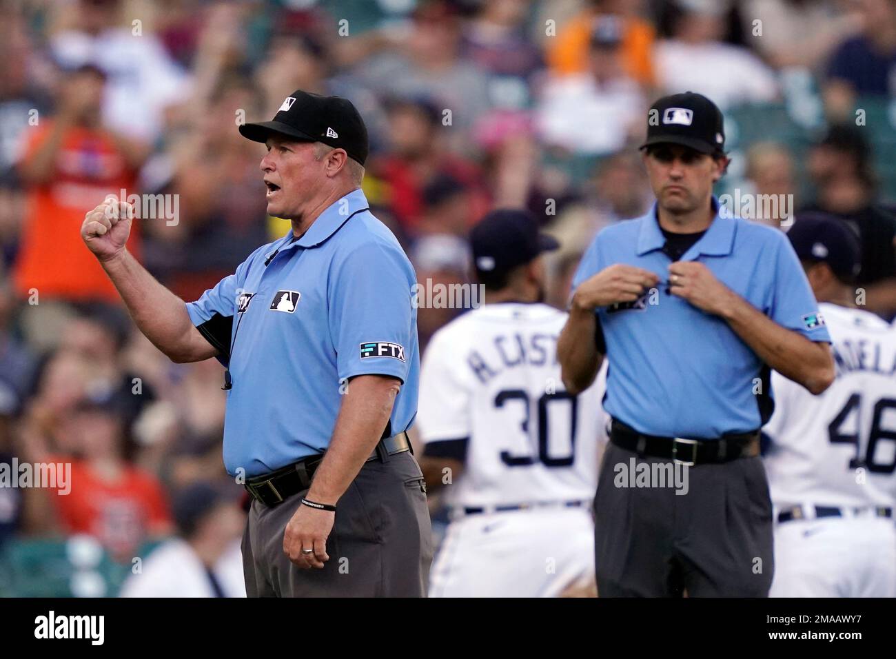 Umpire Marvin Hudson, left, makes the call after a review with umpire ...