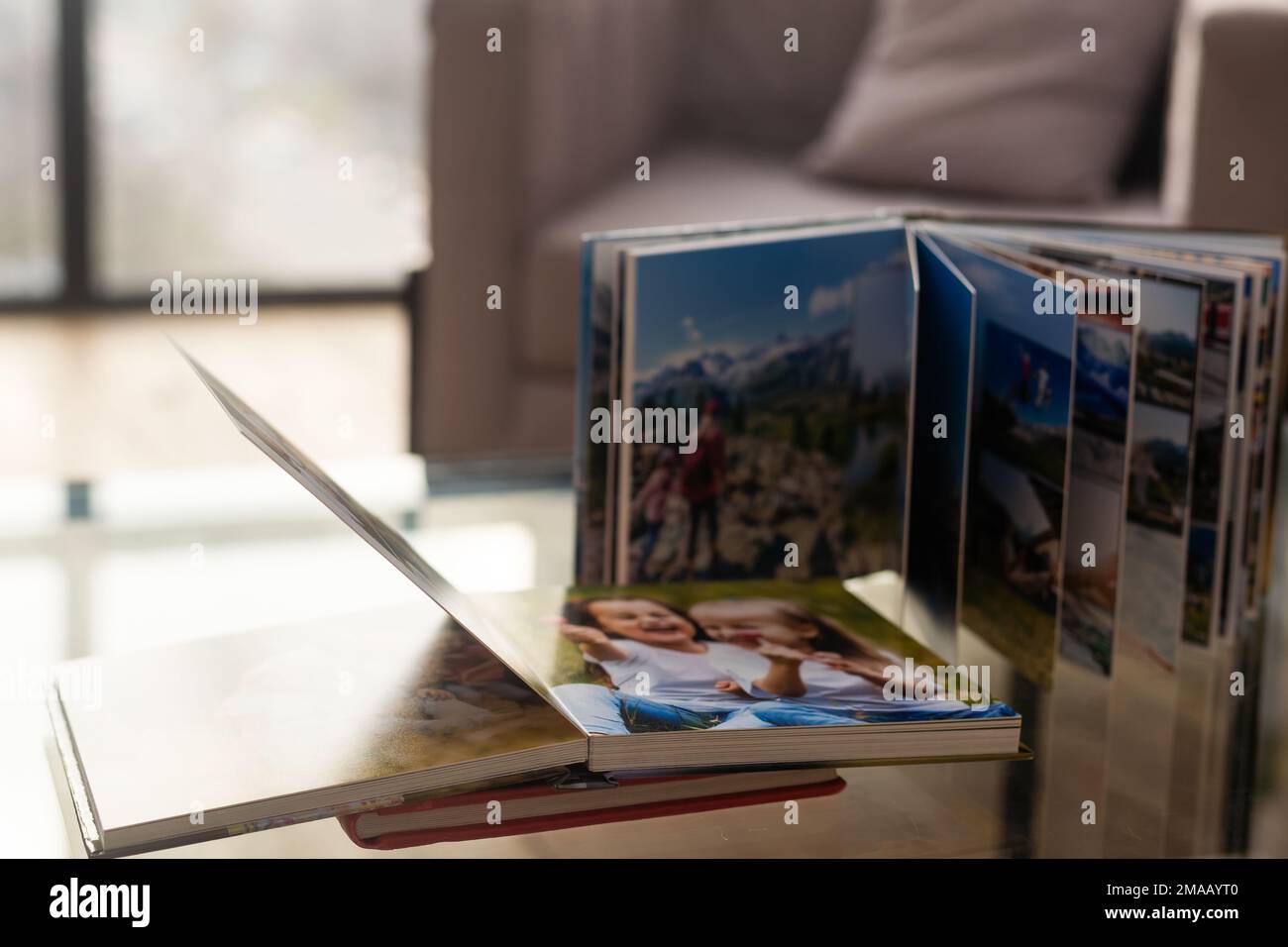 on table open photobook from photo shoot of family. preservation of ...