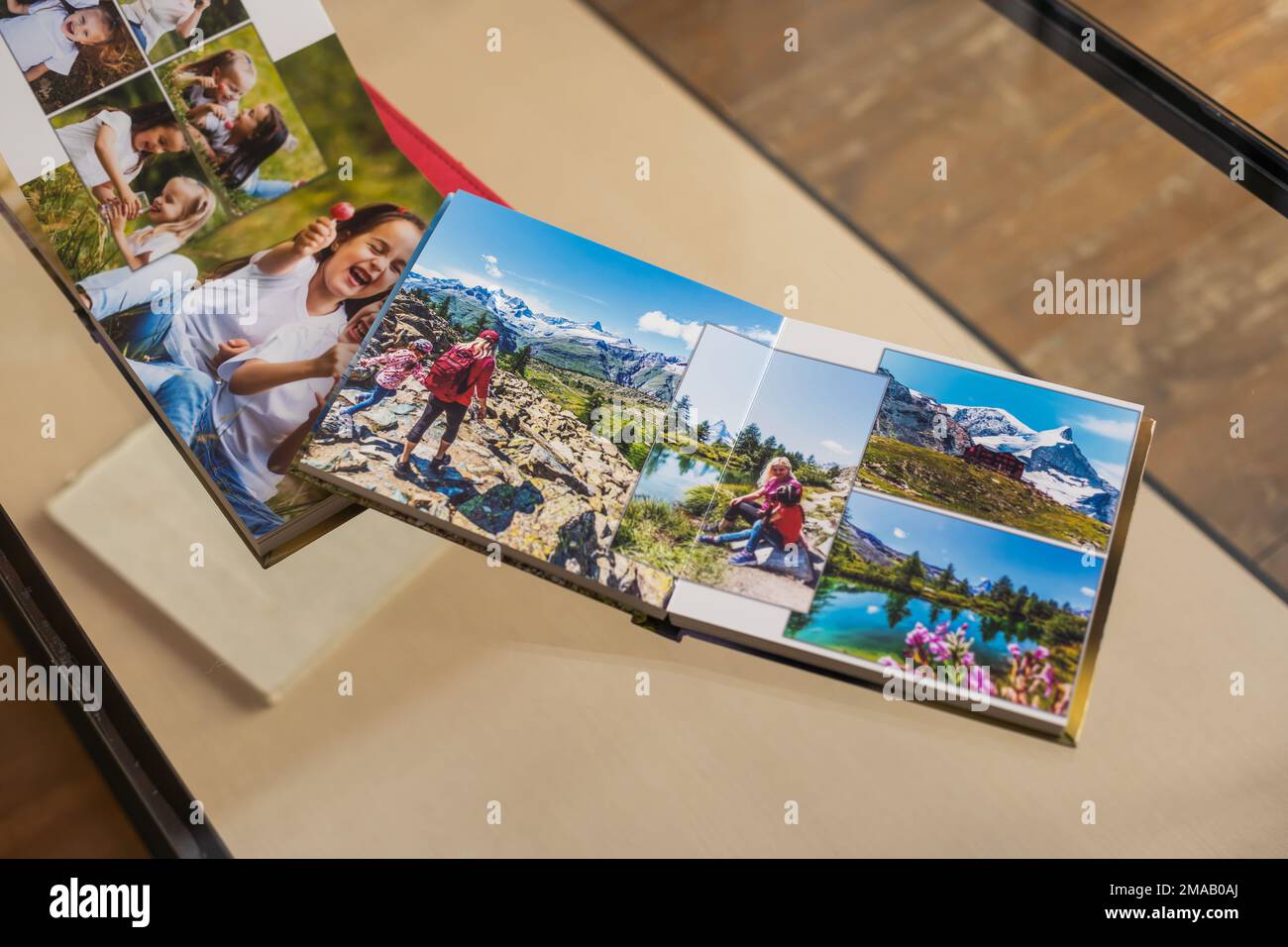 on table open photobook from photo shoot of family. preservation of ...