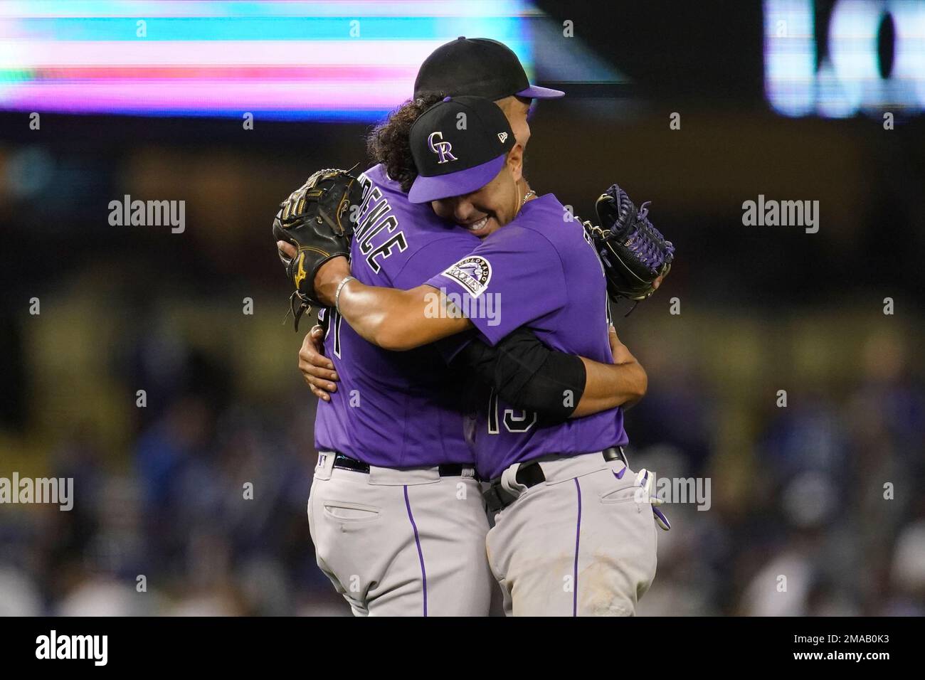 Colorado Rockies relief pitcher Justin Lawrence, left, hugs second ...