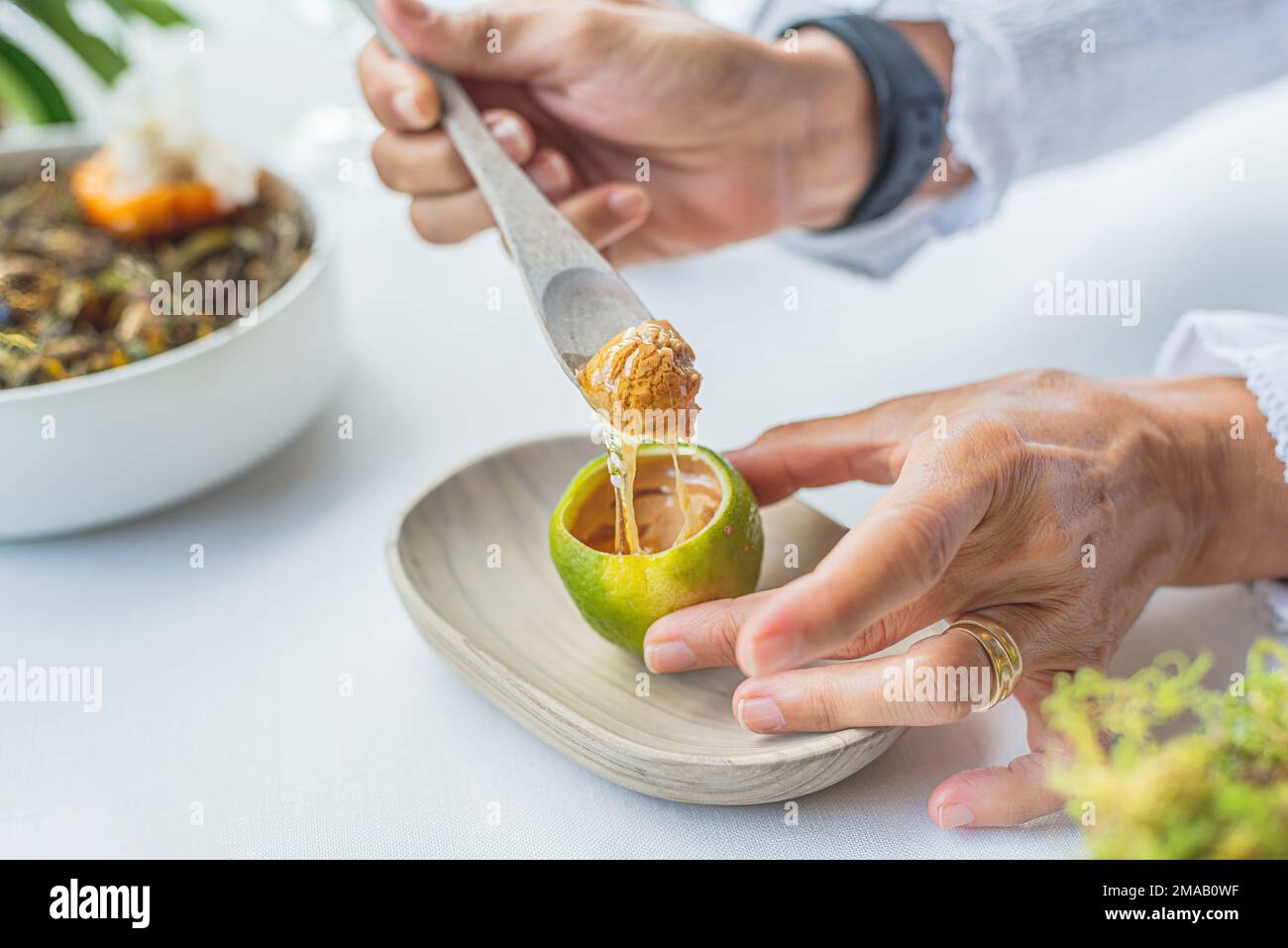 a person tasting a haute cuisine dish based on lemon, foie grass and ...