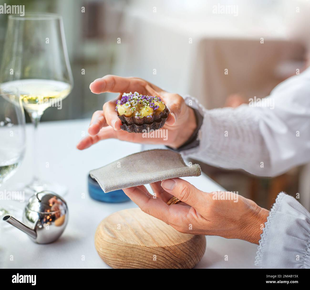 detail of a person tasting a haute cuisine recipe based on beans ...