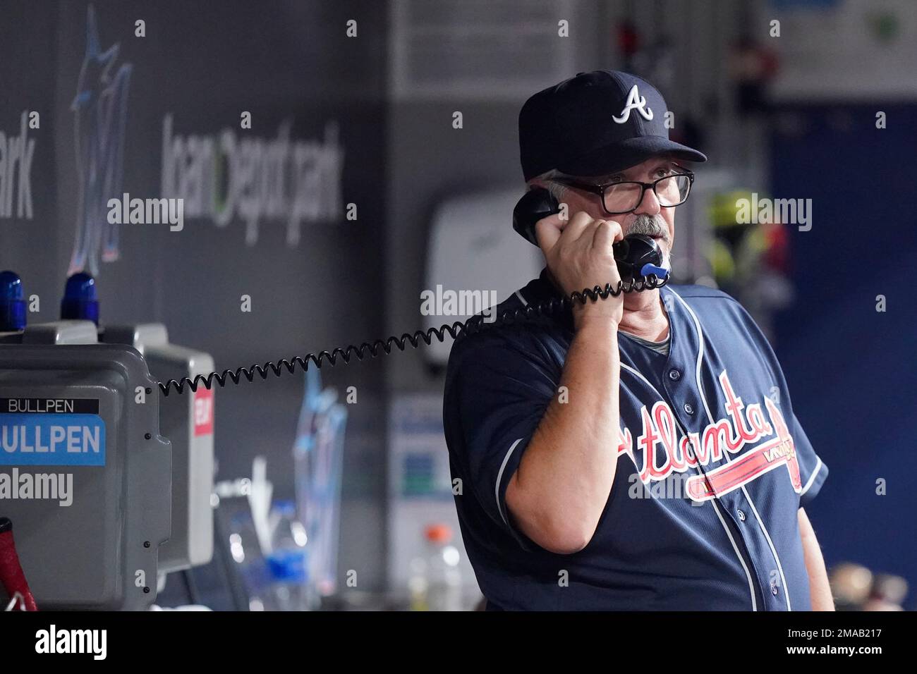 Atlanta Braves pitching coach Rick Kranitz makes a call to the bullpen ...