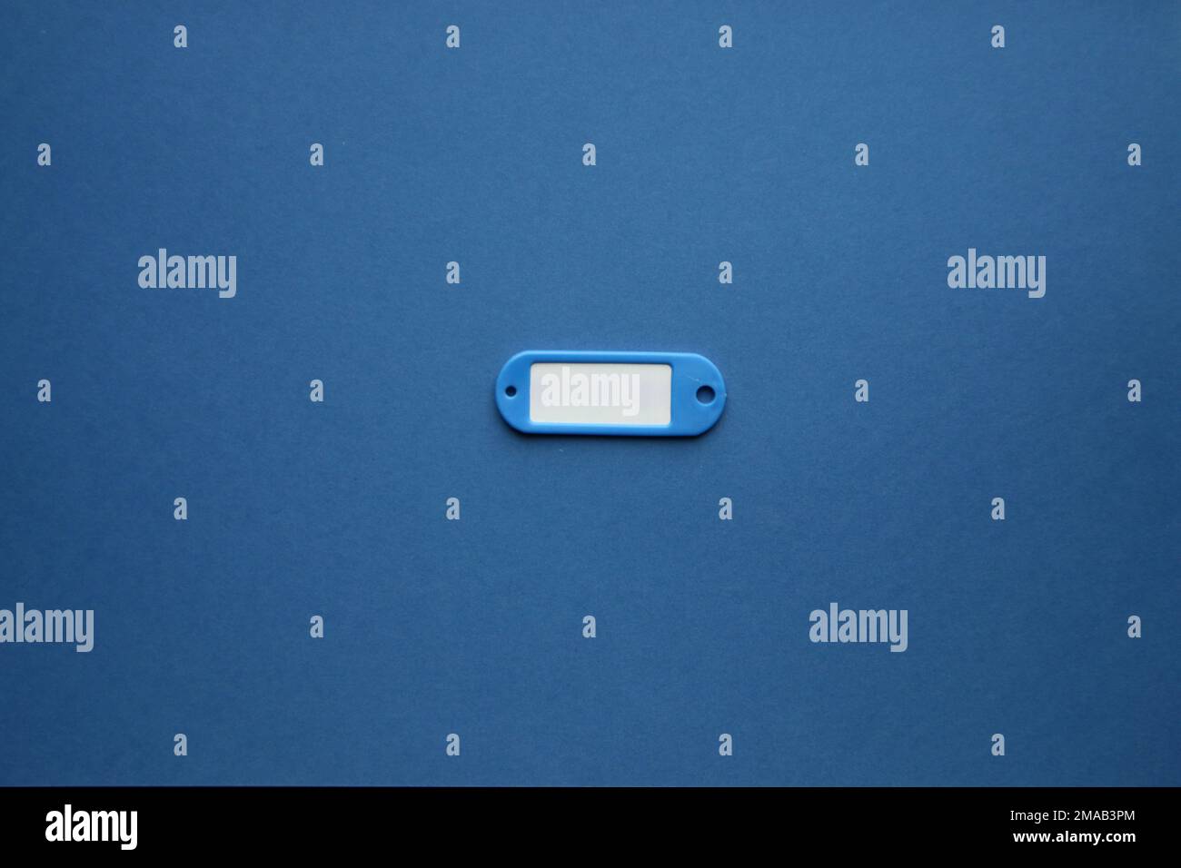 Advertising background, empty tag on a blue background Stock Photo - Alamy