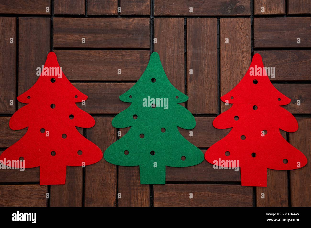 Christmas decorations handmade from red and green felt on a wooden ...