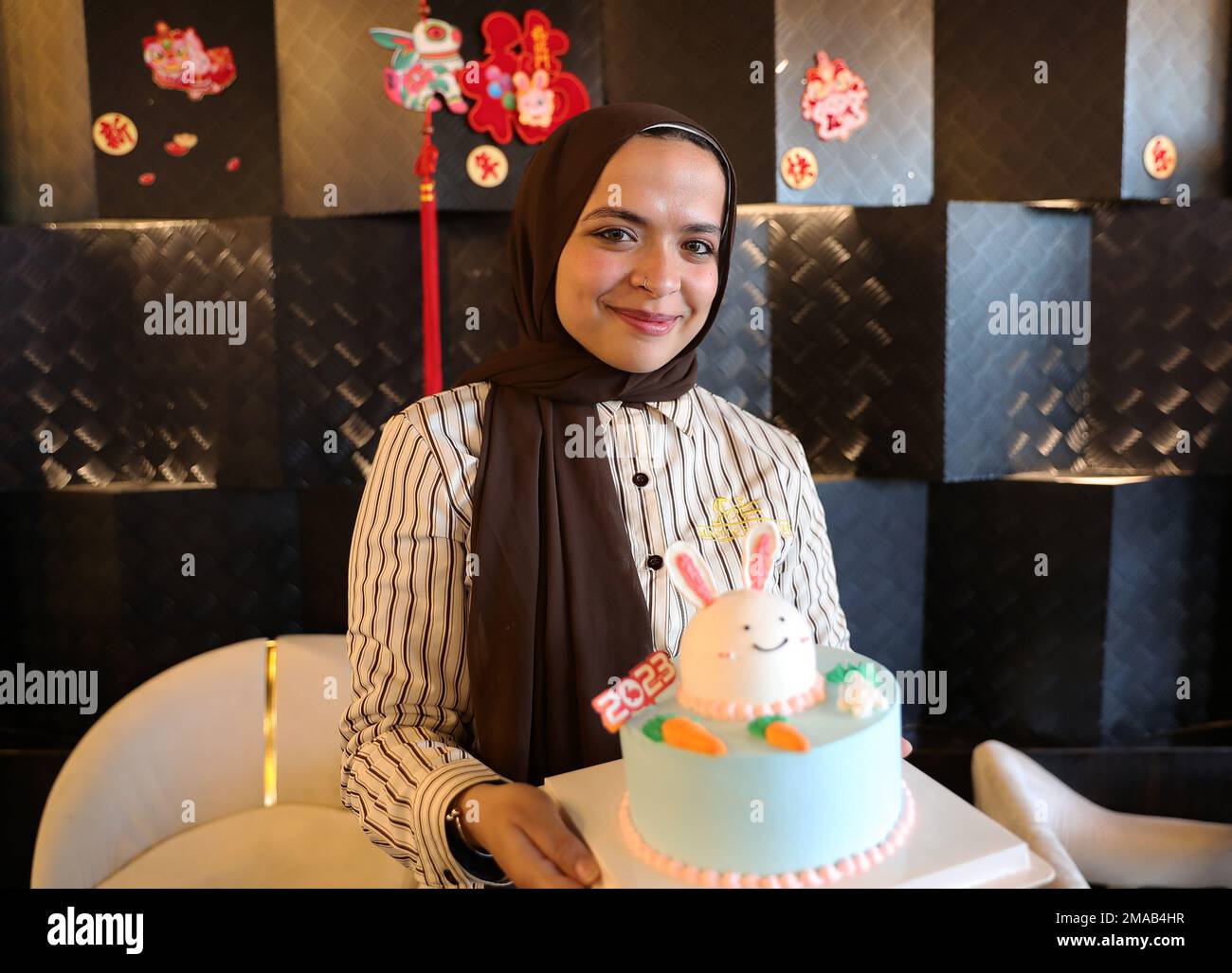 Cairo, Egypt. 18th Jan, 2023. A staff member shows a rabbit-themed cake ...