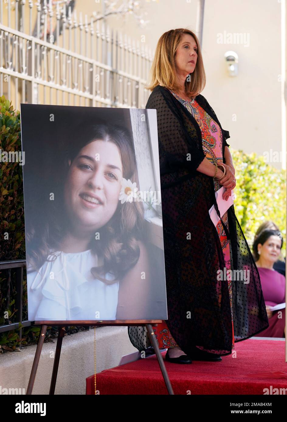 Owen Elliot Kugel Daughter Of The Late Singer Mama Cass Elliot Stands Alongside A Portrait