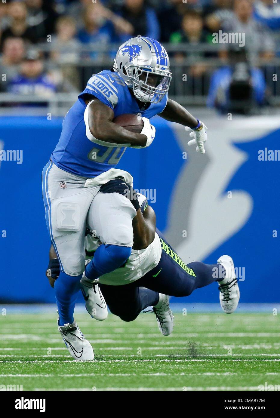 Detroit Lions running back Jamaal Williams (30) is tackled by Seattle ...