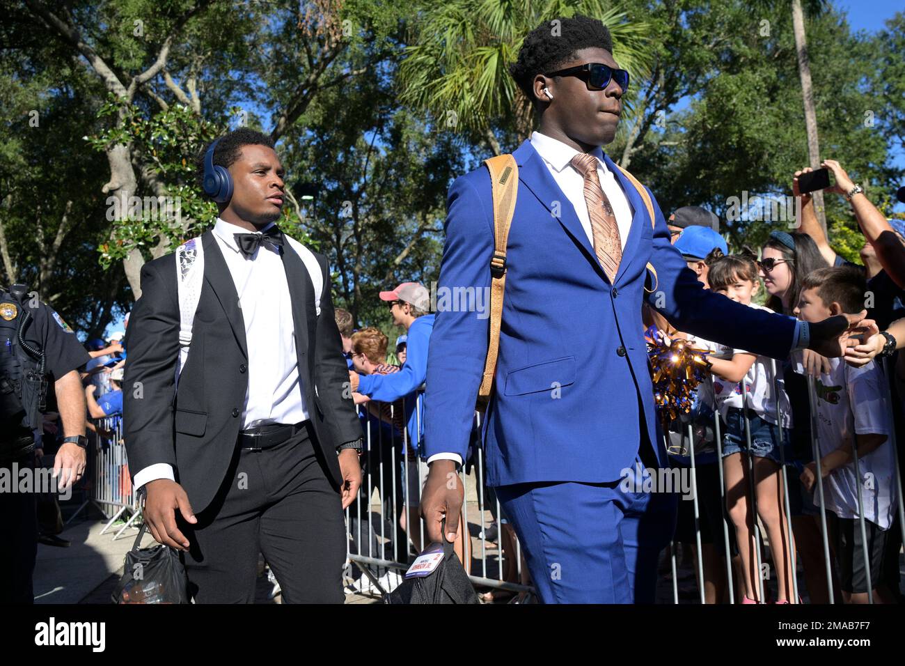 Florida running back Montrell Johnson Jr., right, slaps hands with fans ...