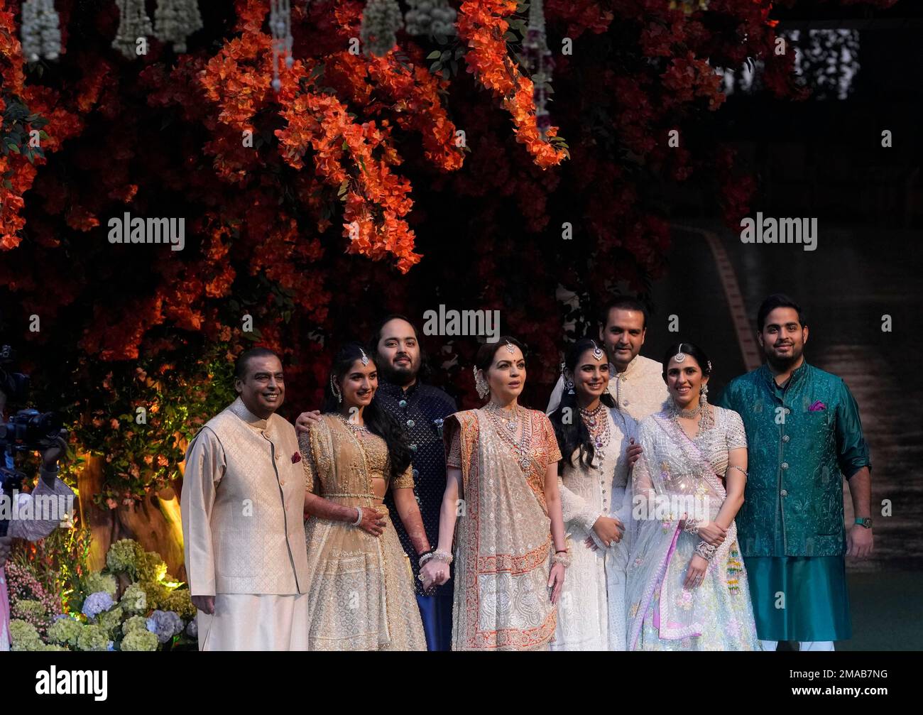 Chairman of Reliance Industries Limited Mukesh Ambani, left, poses with ...
