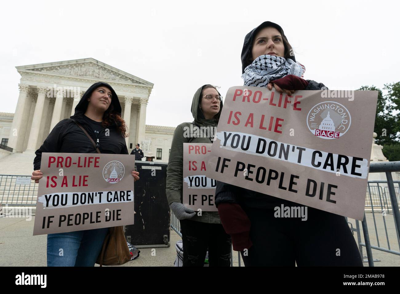 Katherine Faddol, right, Rachel Hubert, and Rayna Reyst, left, hold ...