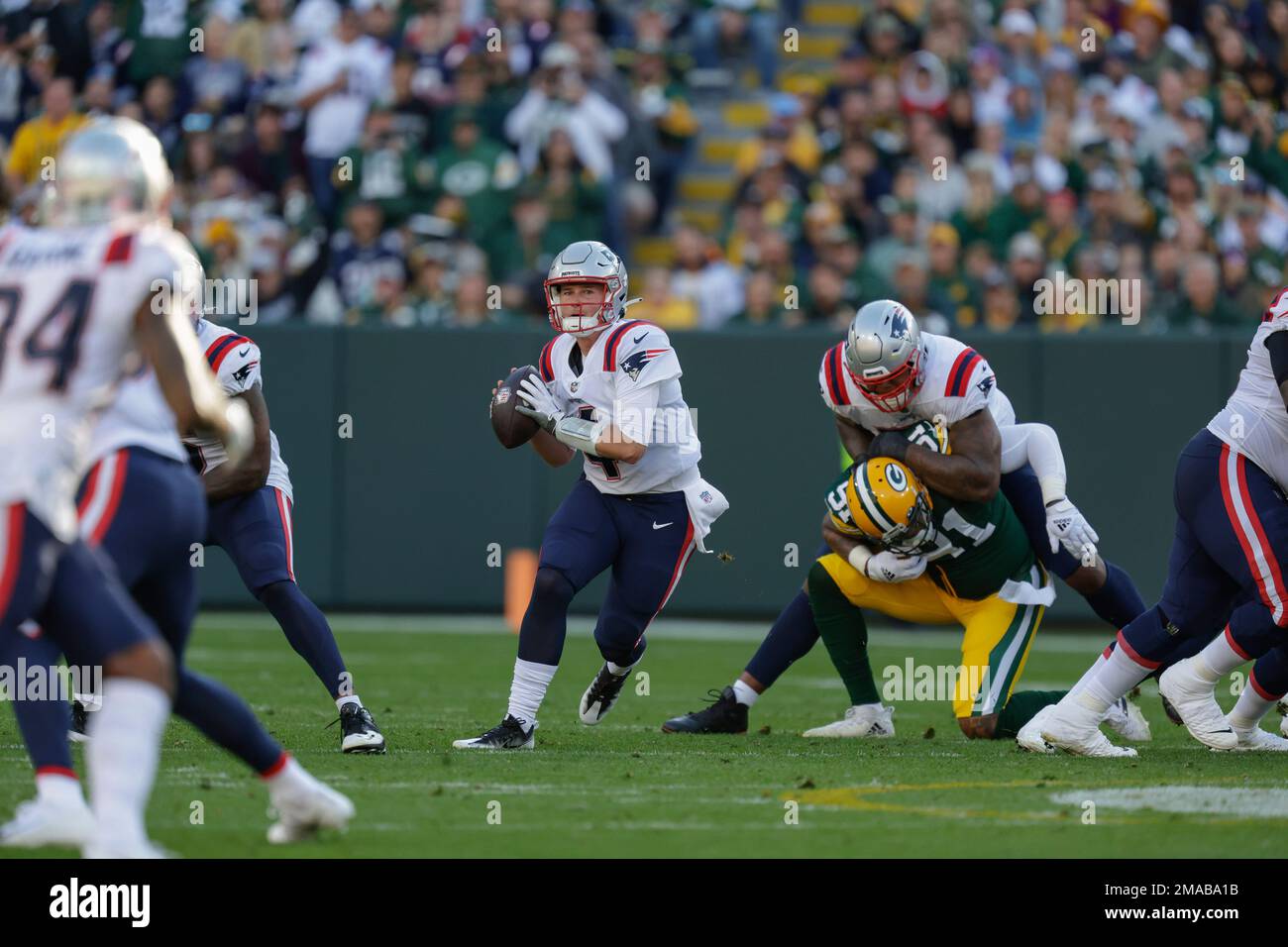 New England Patriots quarterback Bailey Zappe (4) scrambles in the ...