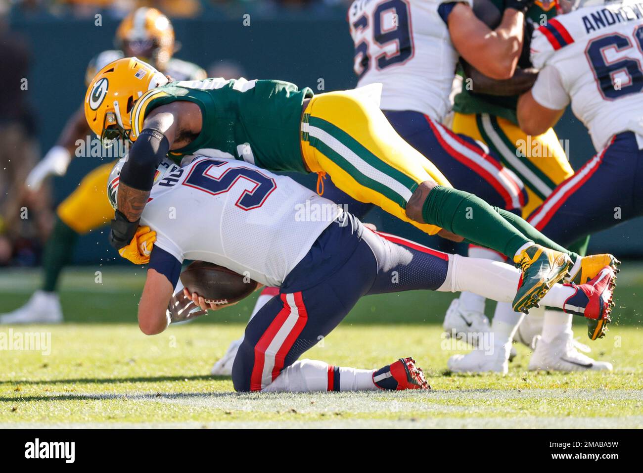 New England Patriots quarterback Brian Hoyer (5) is sacked by Green Bay ...