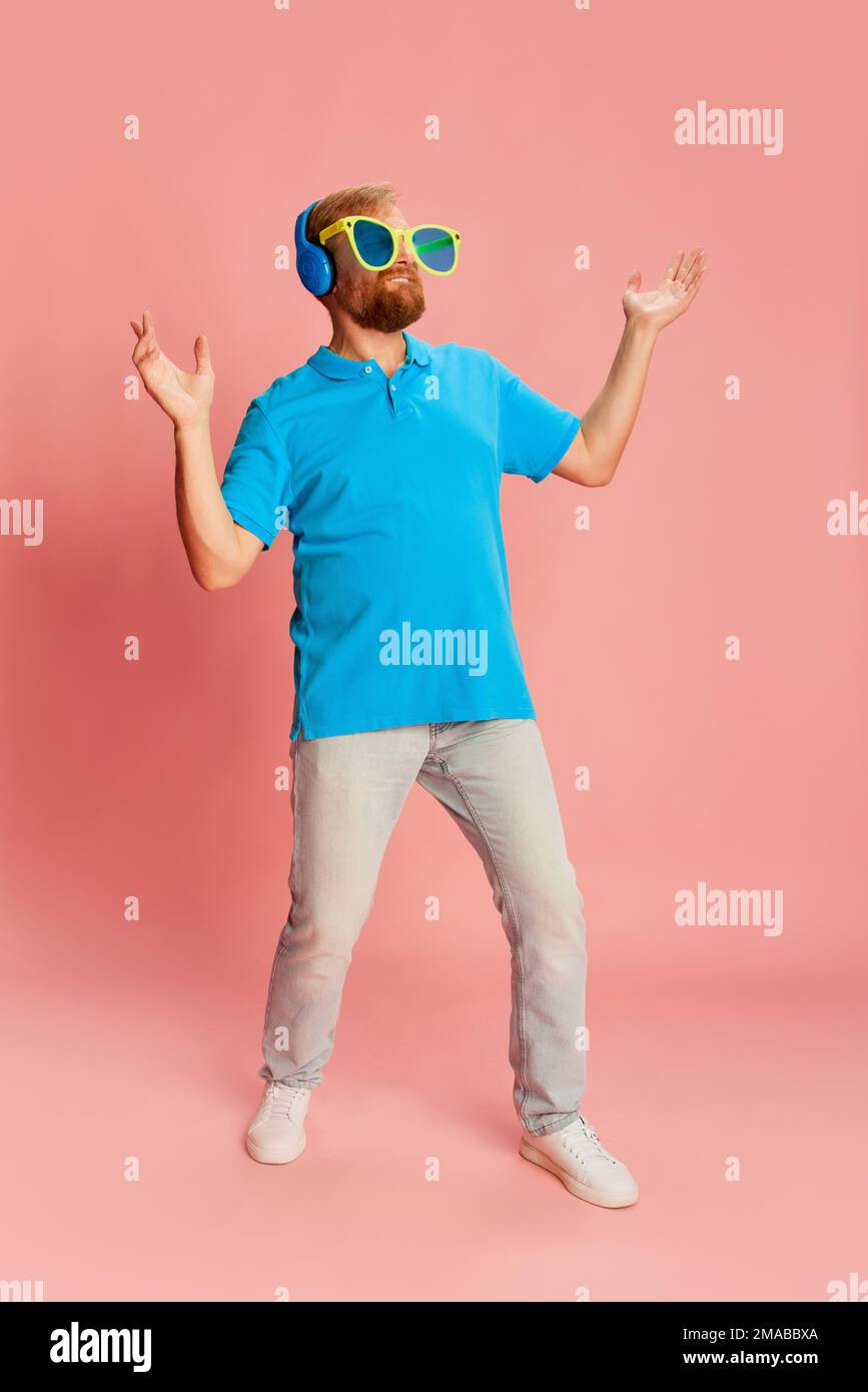 Happy man in casual style clothes and funny huge eyewear with funky ...