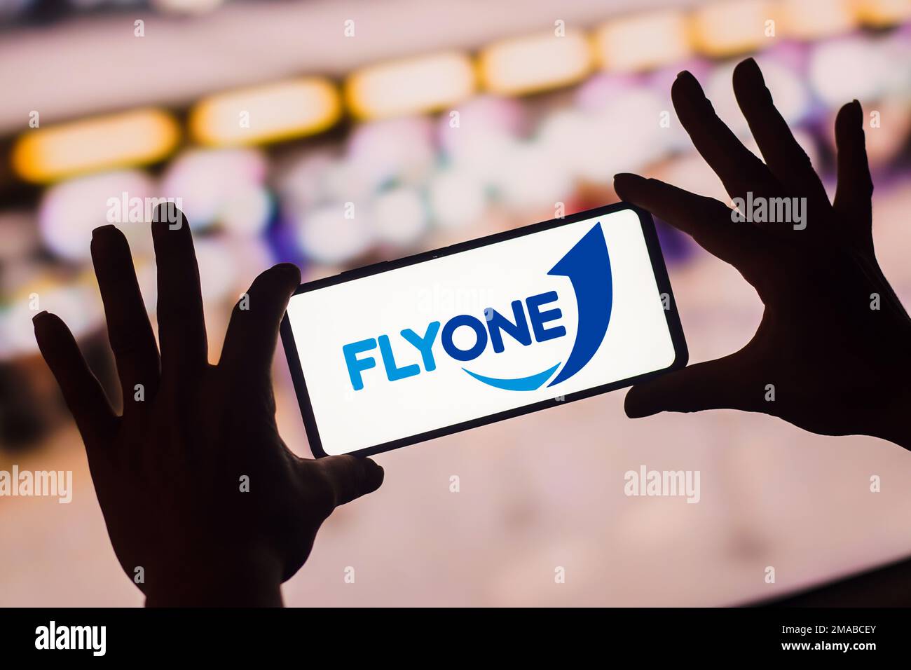 In this photo illustration, the FlyOne logo is displayed on a ...