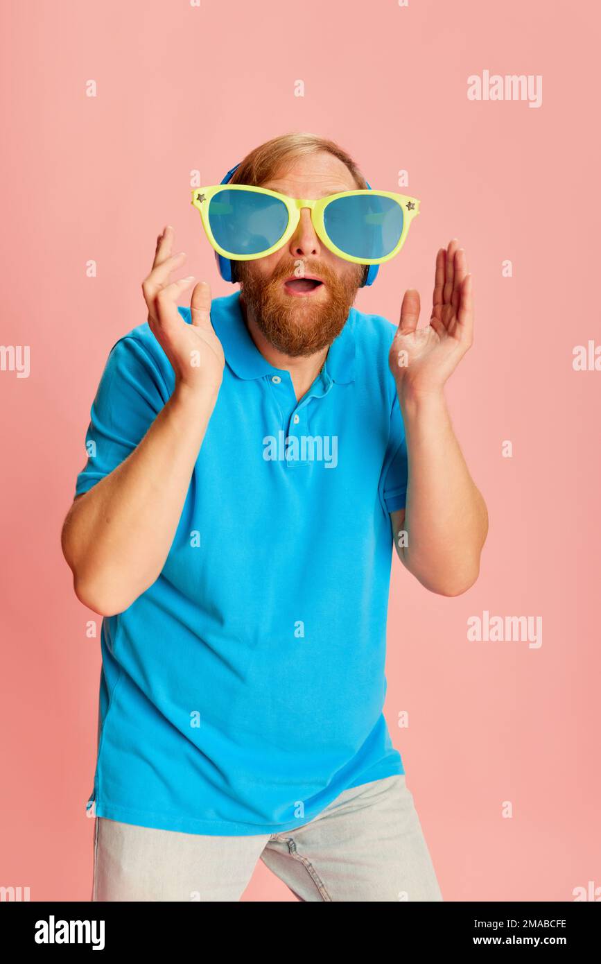 Happy man in casual style clothes and funny huge eyewear with funky ...