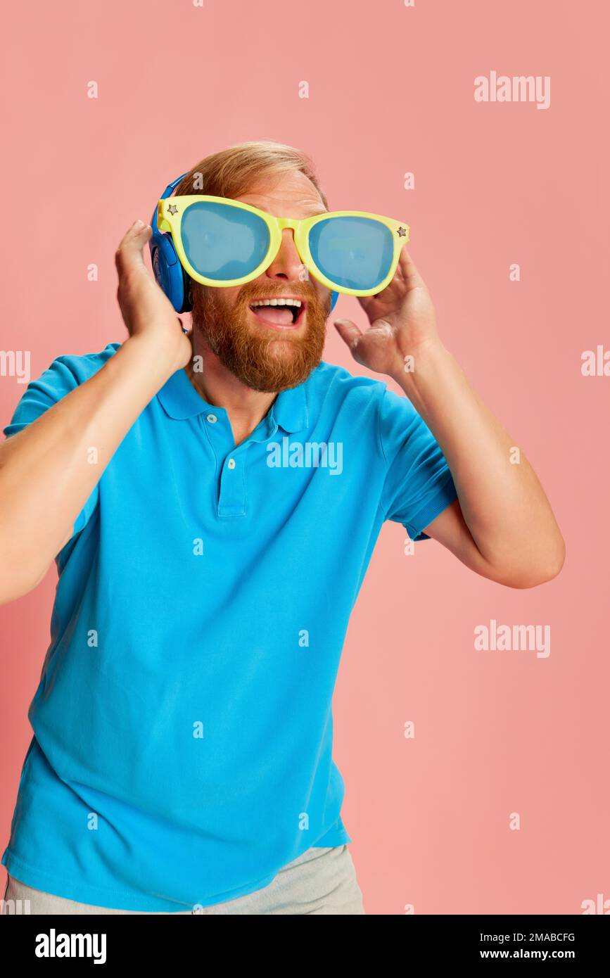 Happy man in casual style clothes and funny huge eyewear with funky ...