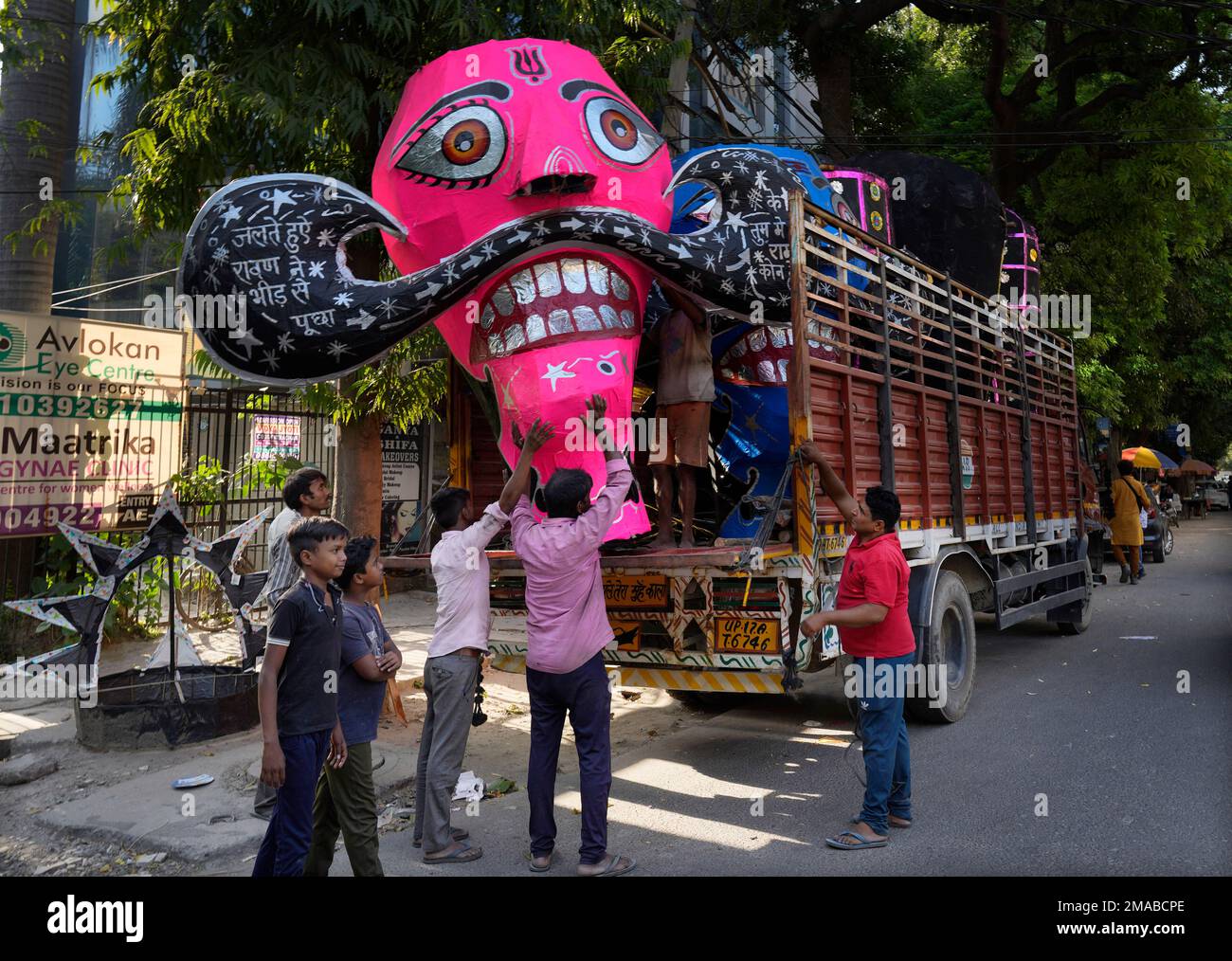 Workers load effigies of Demon King Ravana into a truck for the ...