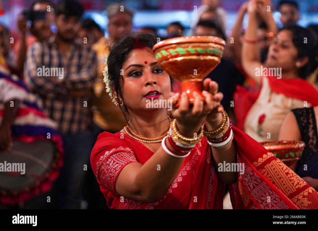 Devotees perform a traditional dance in front of an idol of Hindu ...