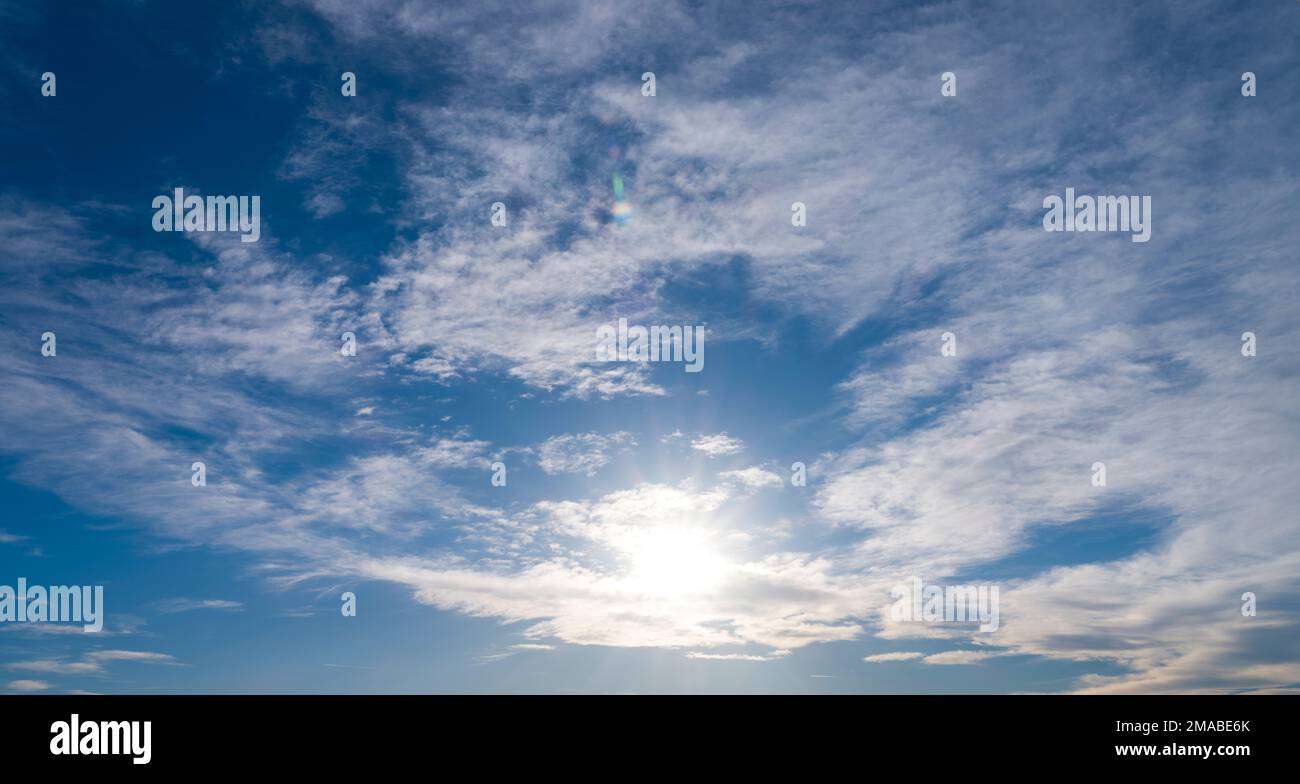 Sunbeams among white clouds in blue sky. sky background Stock Photo - Alamy