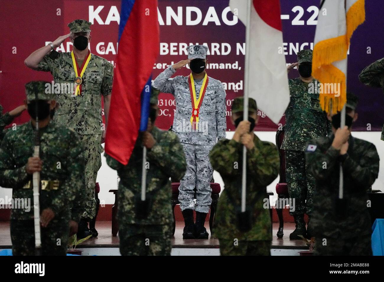 Philippine Navy Rear Adm. Caesar Bernard Valencia, center, acting Flag ...