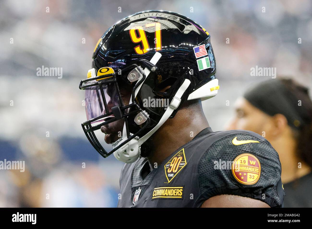 Washington Commanders defensive end Efe Obada (97) displays a US and ...
