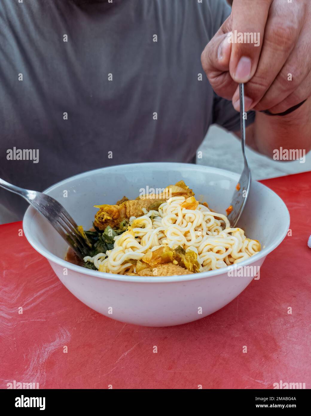 Eating Mee Ayam, Mie ayam, a noodles with chicken, meatballs, dumplings ...