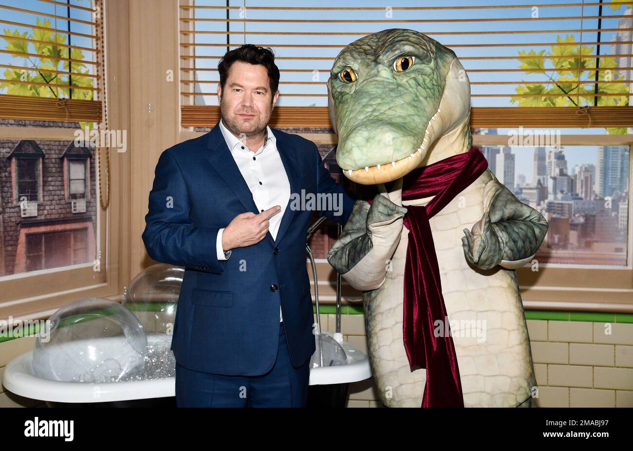 Producer-director Josh Gordon, left, poses with the Lyle Crocodile ...