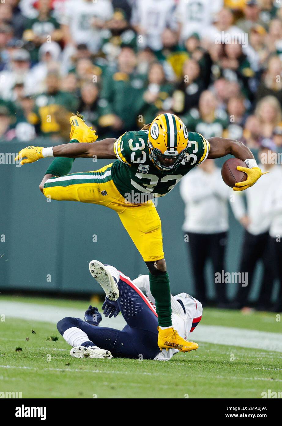 Green Bay Packers running back Aaron Jones (33) leaps over a New ...