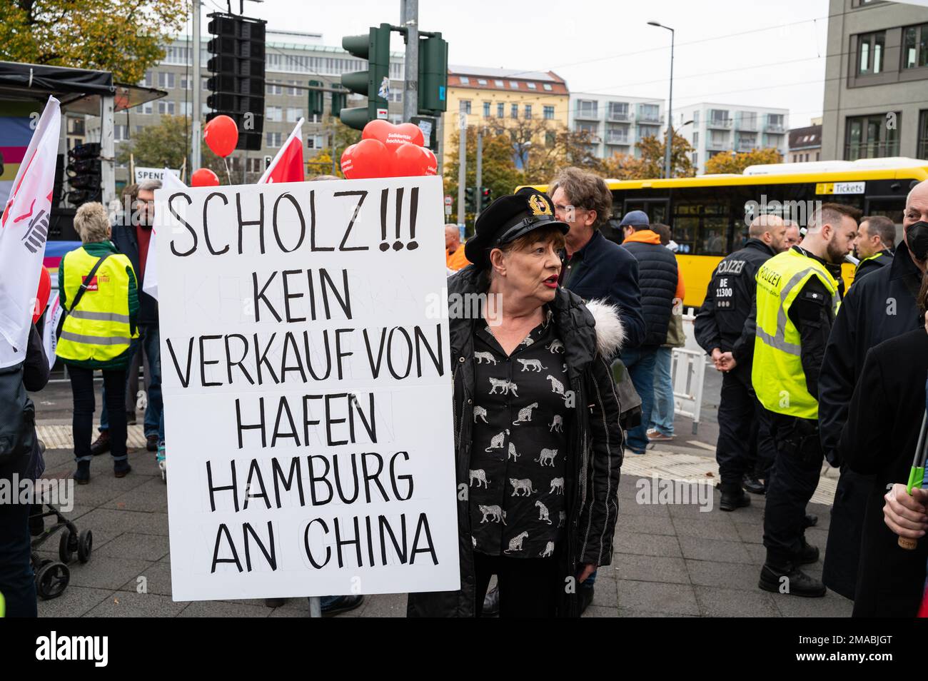 22.10.2022, Germany, , Berlin - Activist holds a protest poster against ...