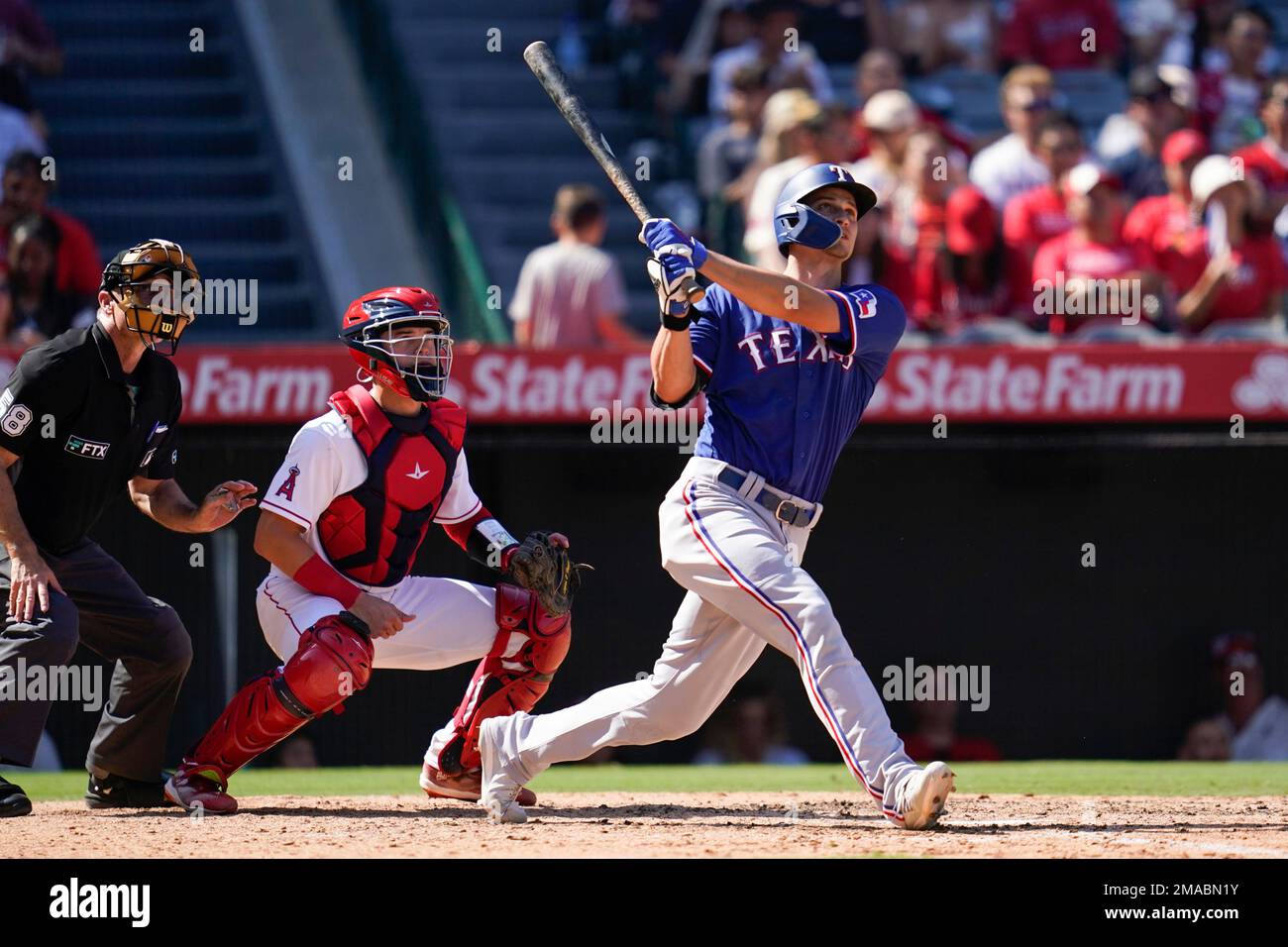 Texas Rangers' Corey Seager, right, hits a home run during the fifth inning of a baseball game ...