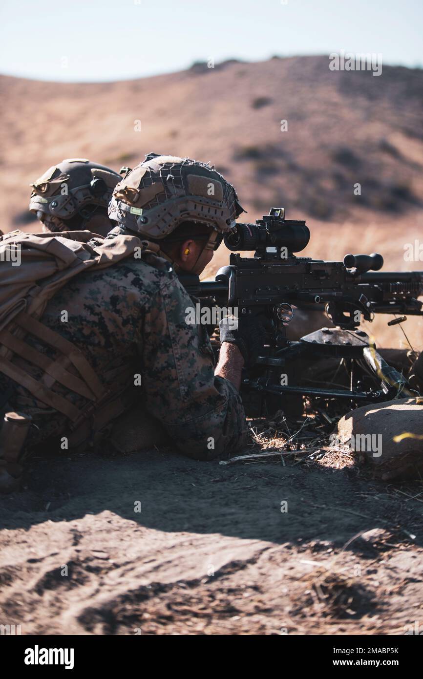 A U.S. Marine with 1st Marine Regiment, 1st Marine Division, fires an ...