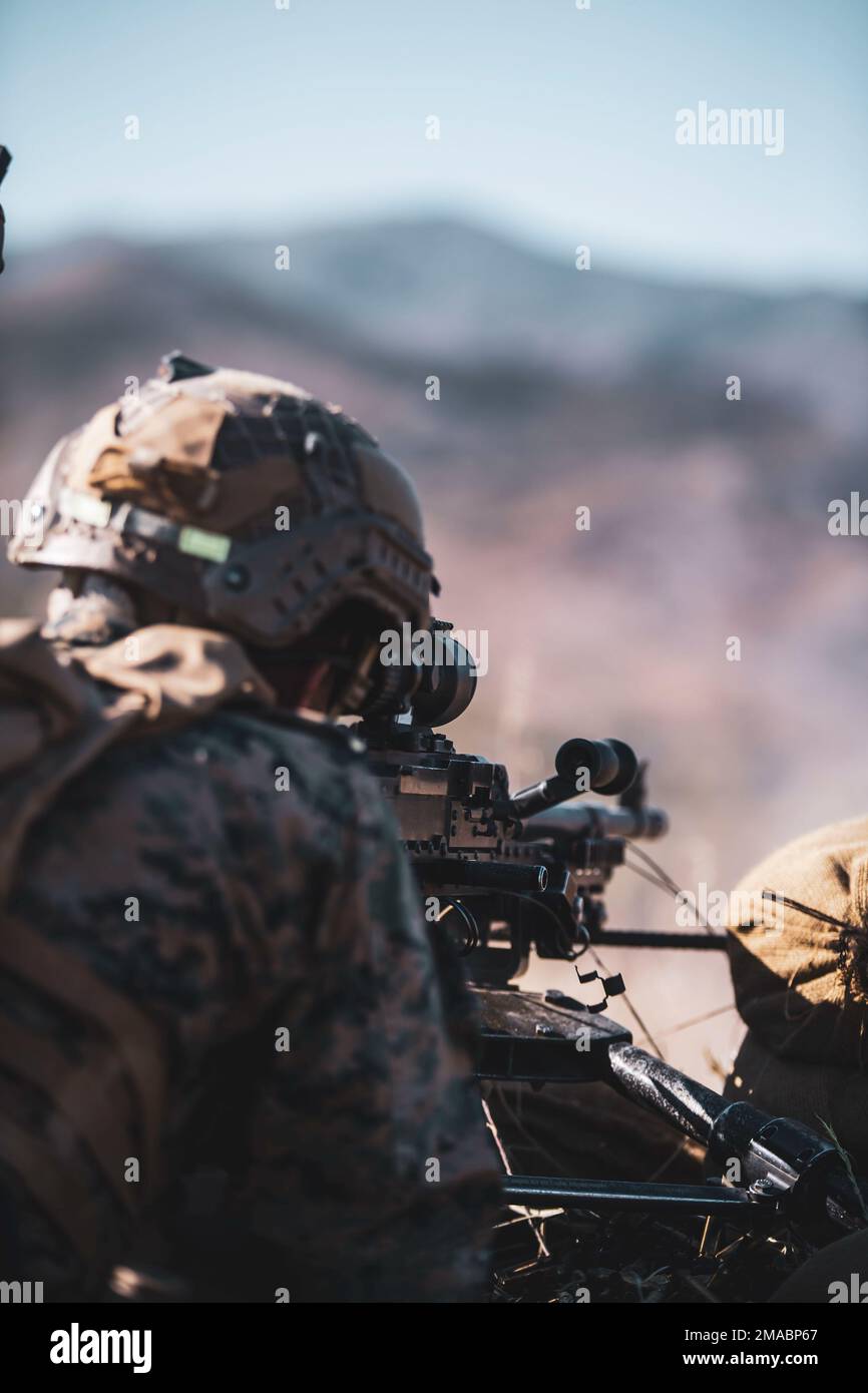 A U.S. Marine with 1st Marine Regiment, 1st Marine Division, fires an ...