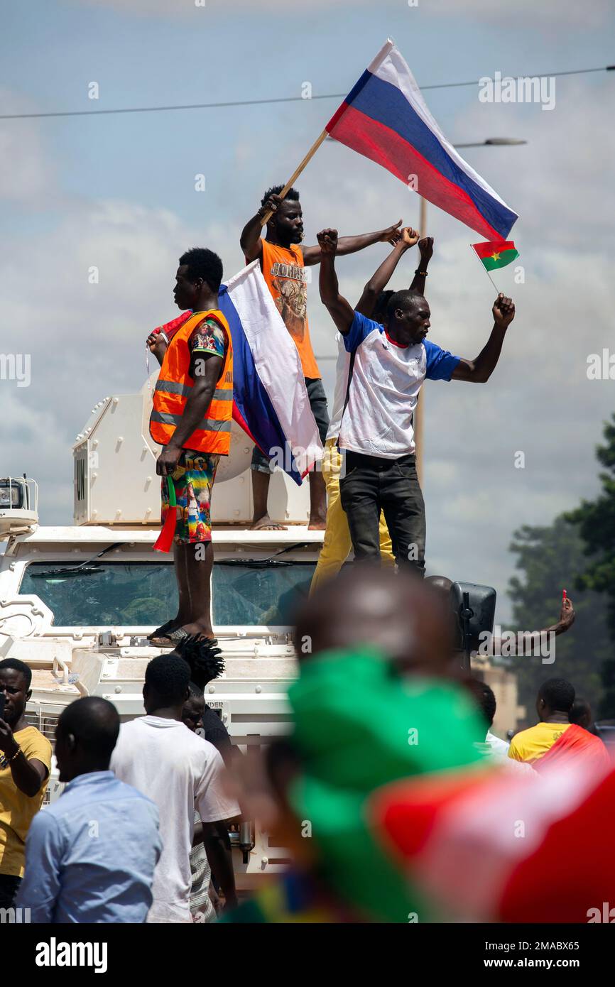 Supporters of Capt. Ibrahim Traore wave Russian flags as they cheered ...