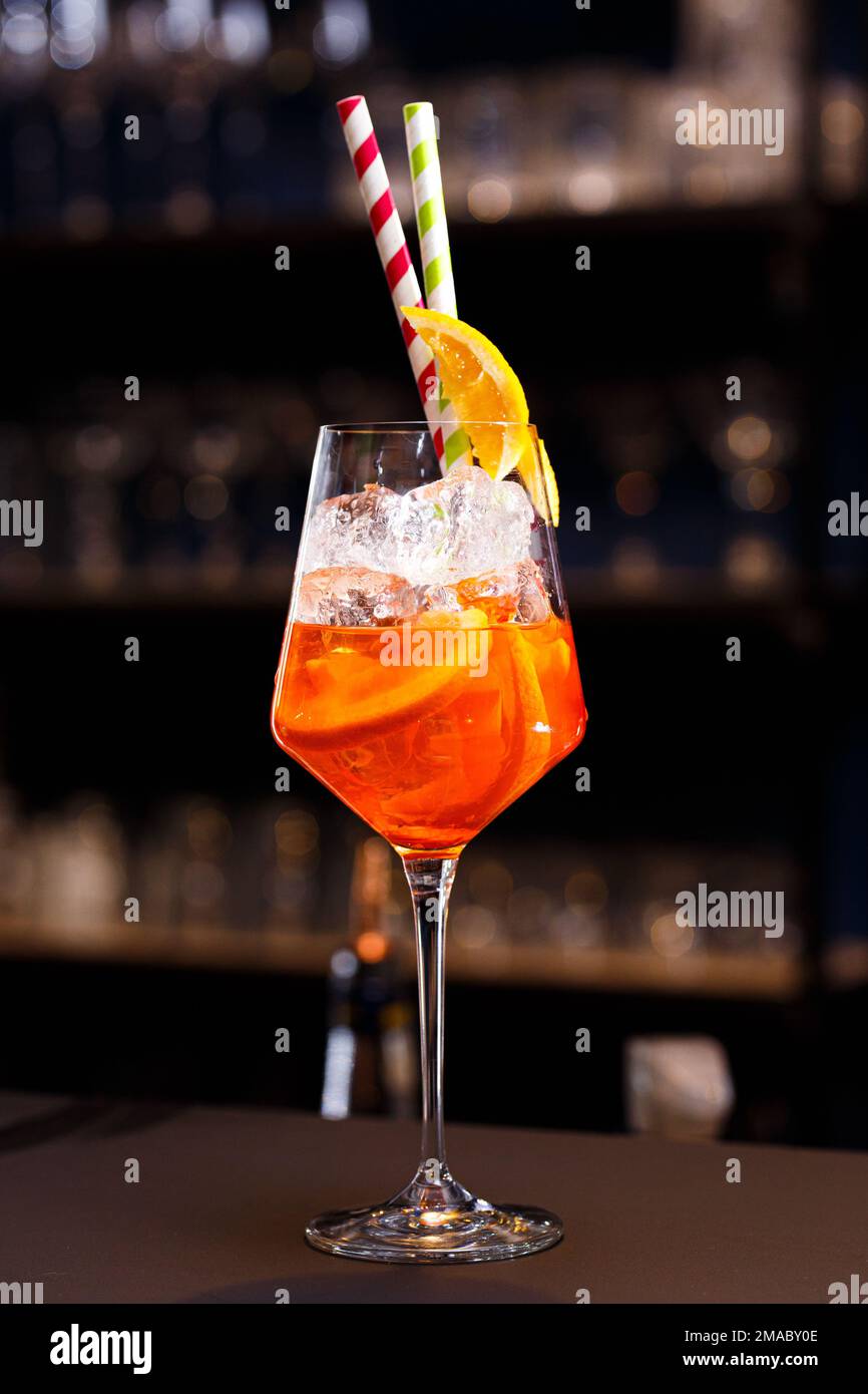 Orange cocktails with ice cubes and straws on the bar counter Stock ...