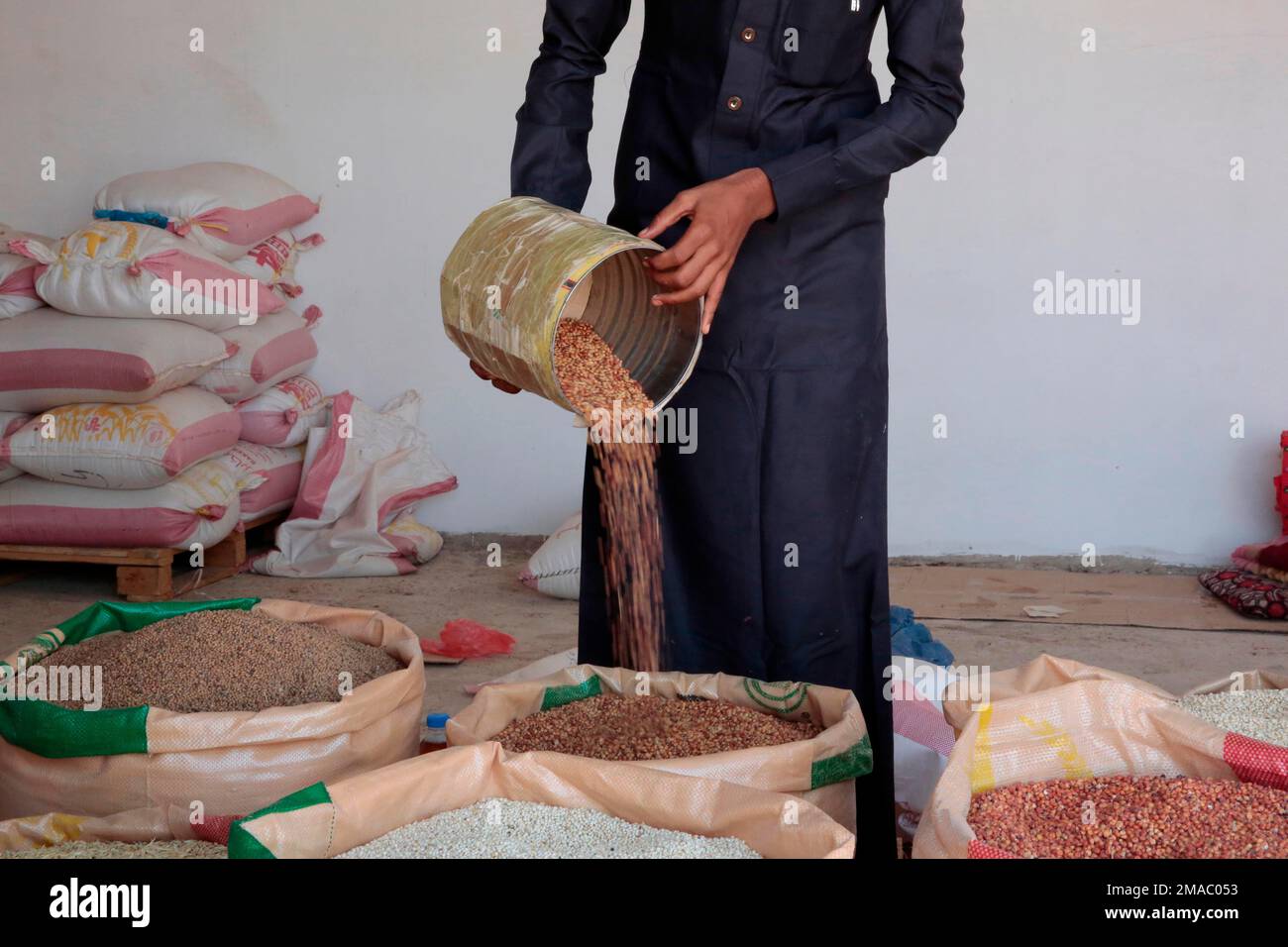 A Yemeni vendor displays various types of dry goods at a traditional ...