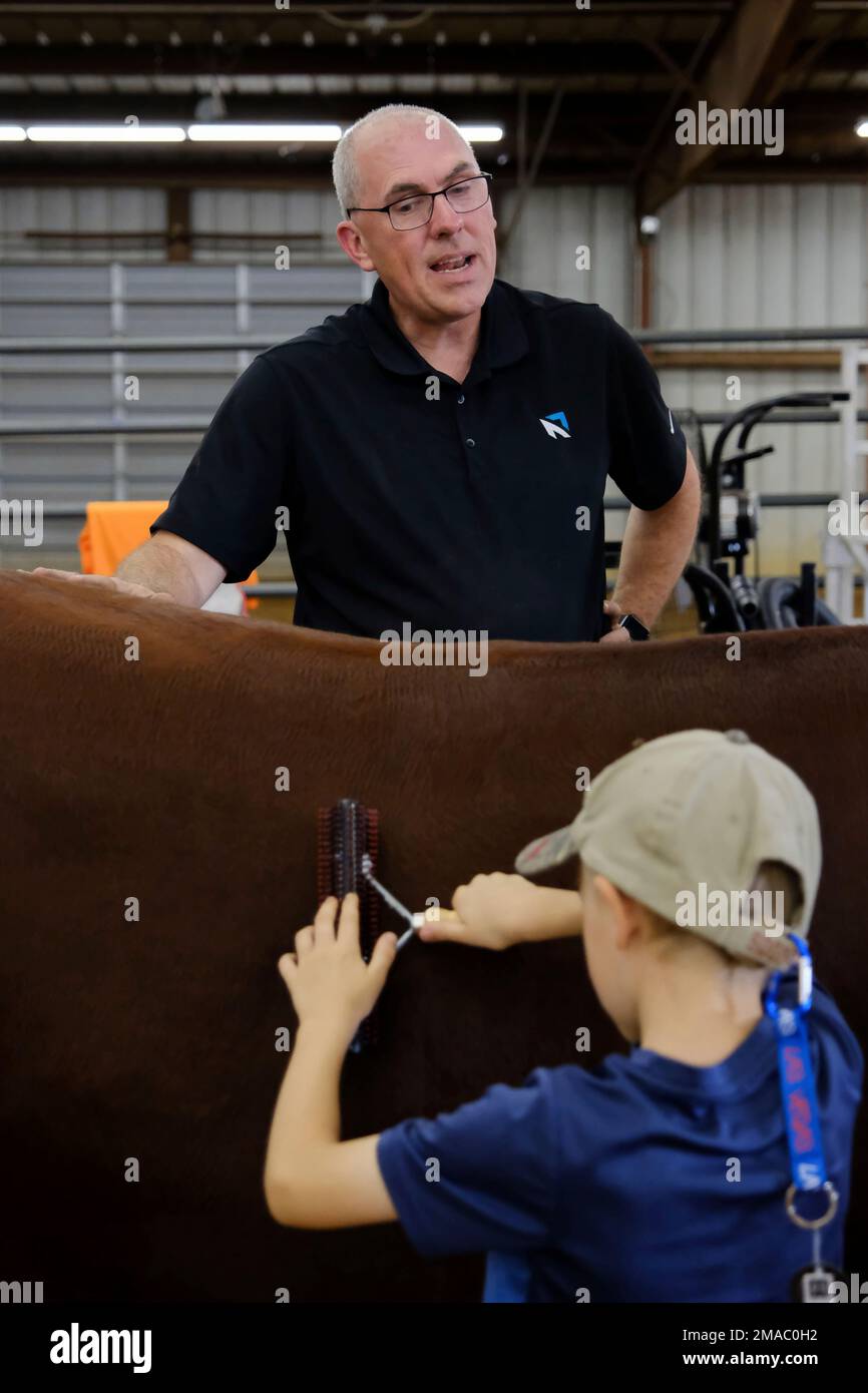 Bart Barber gives Caleb Coblentz, 5, tips on brushing heifers at a 4-H ...