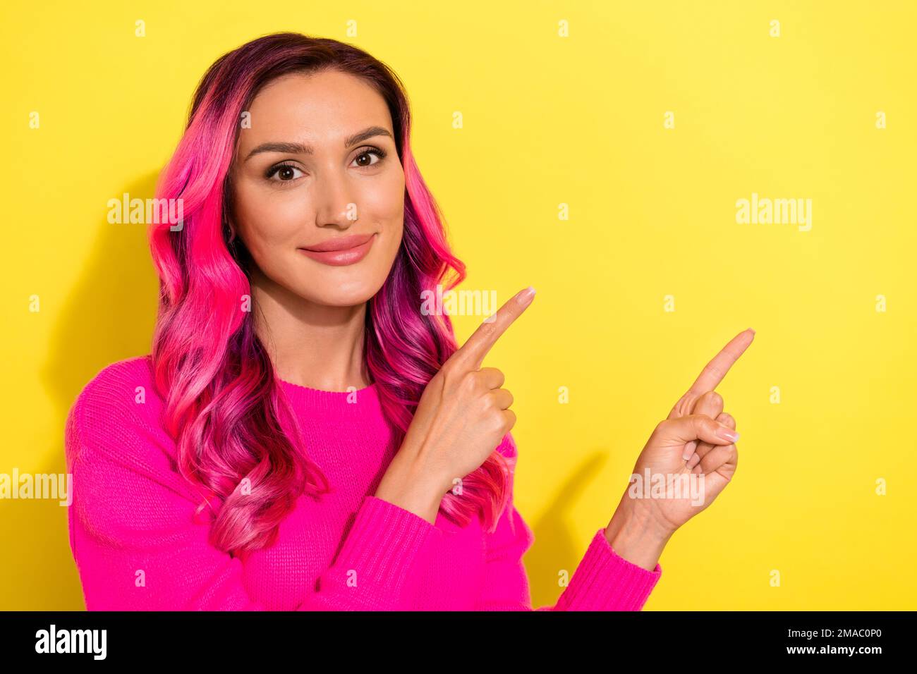 Photo of funky shiny girl dressed vibrant pullover pointing two fingers ...
