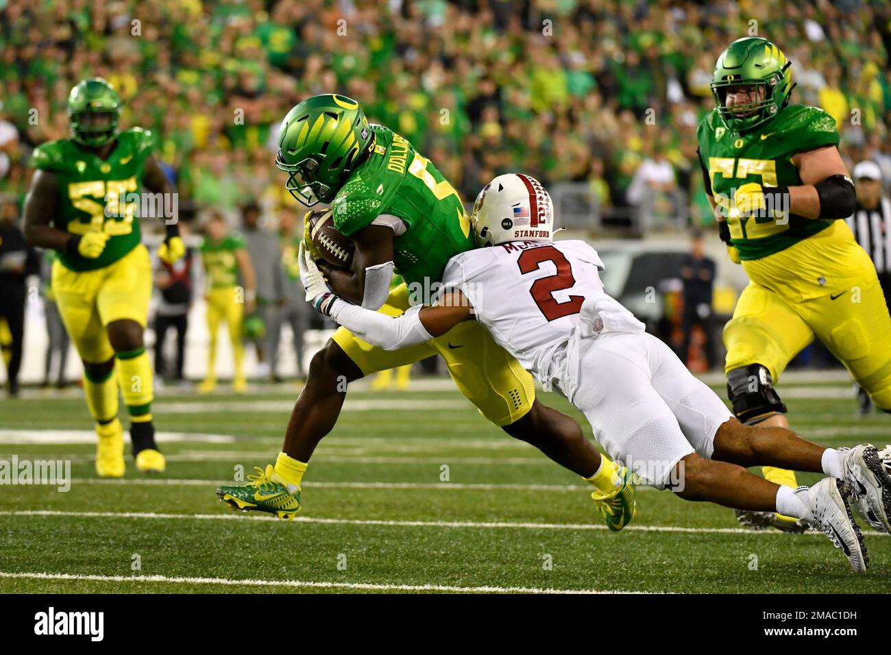 Oregon running back Sean Dollars (5) is tackled by Stanford safety ...