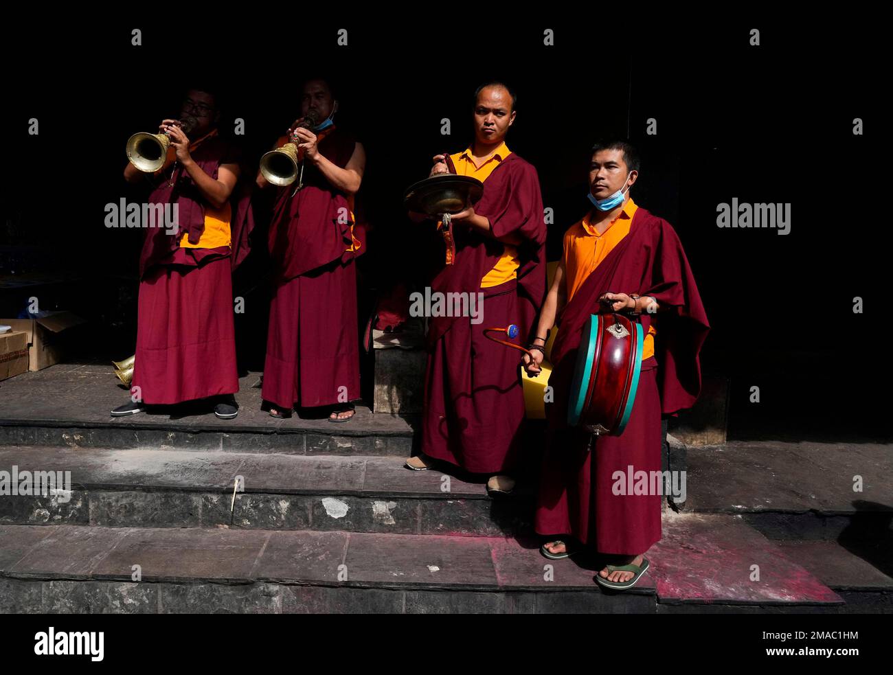 Buddhist monks play traditional instruments as they performs rituals ...