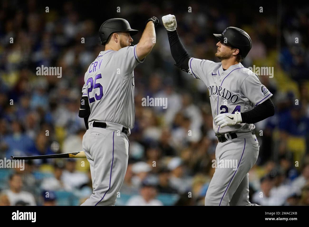 Colorado Rockies' Ryan McMahon, right, celebrates his solo home run ...