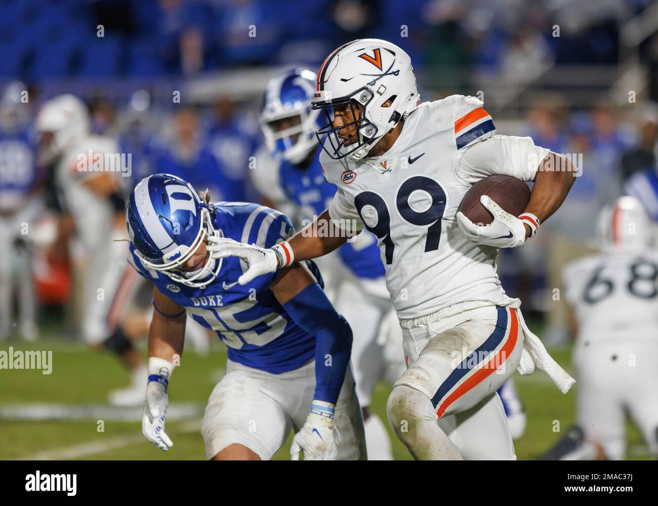 Virginia's Keytaon Thompson (99) carries the ball past Duke's Cam ...