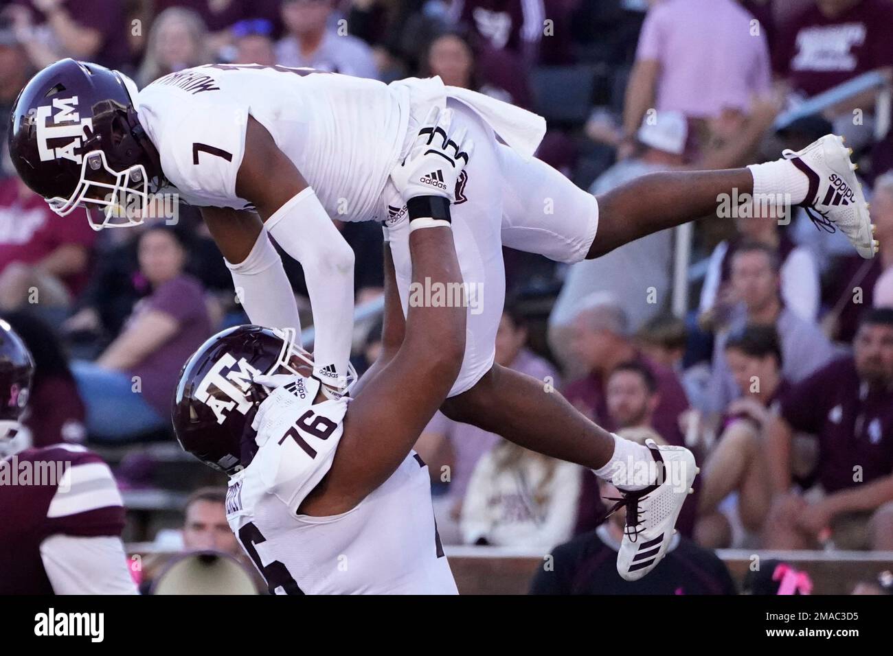 Texas A&M offensive lineman Reuben Fatheree II (76) lifts teammate wide ...