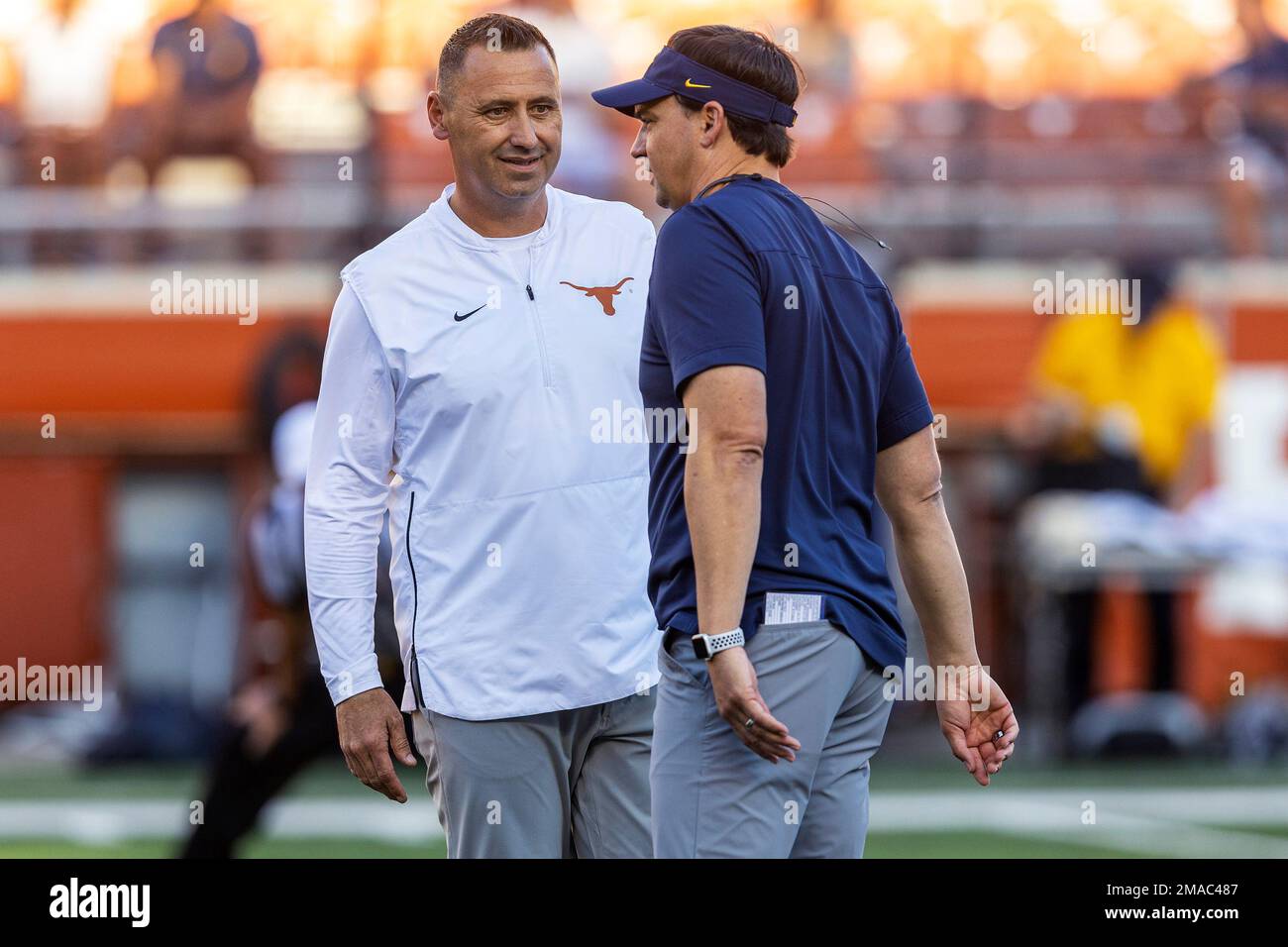 Texas coach Steve Sarkisian, left, and West Virginia coach Neal Brown ...