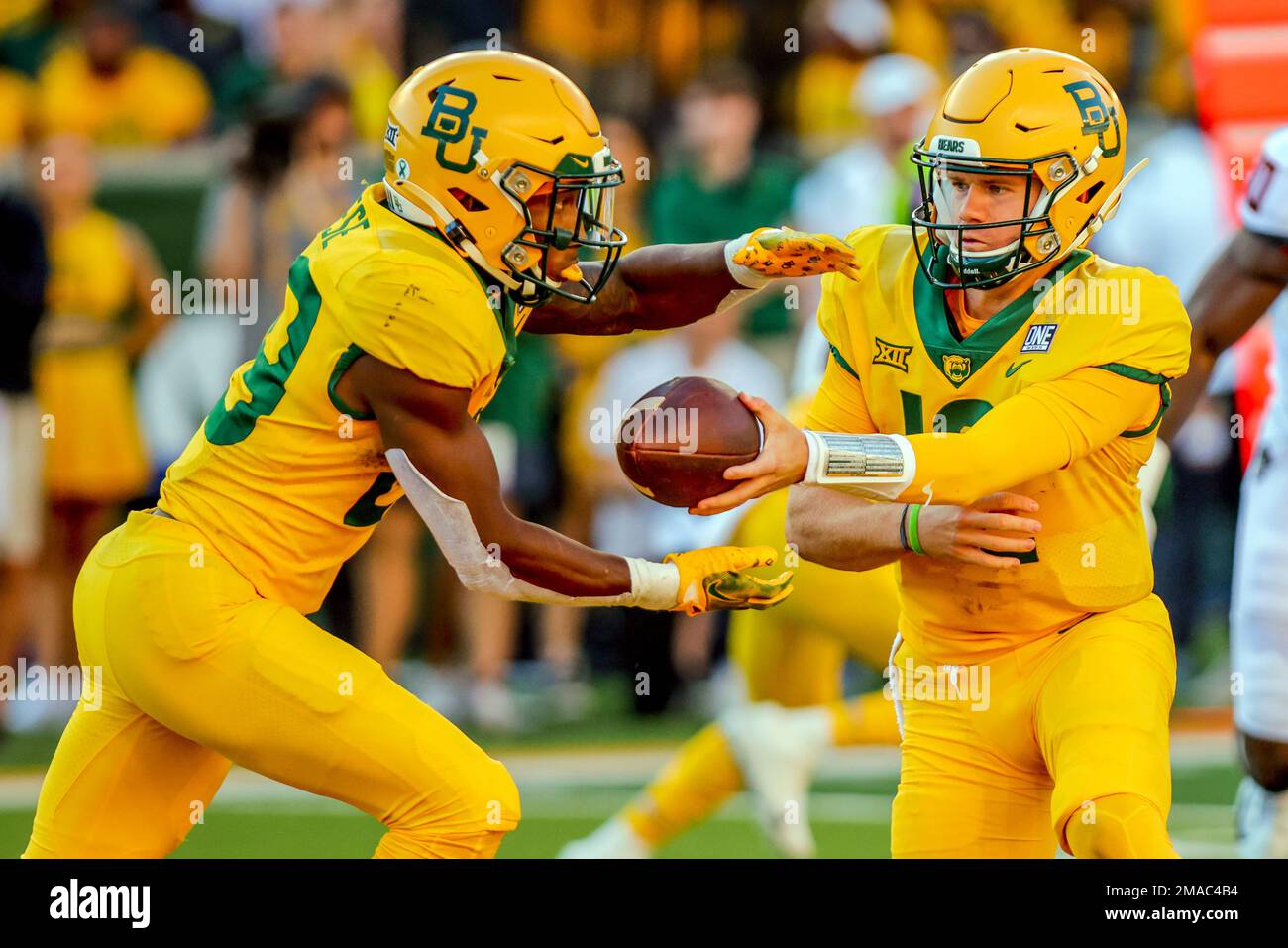 Baylor quarterback Blake Shapen, right, hands the ball to running back ...