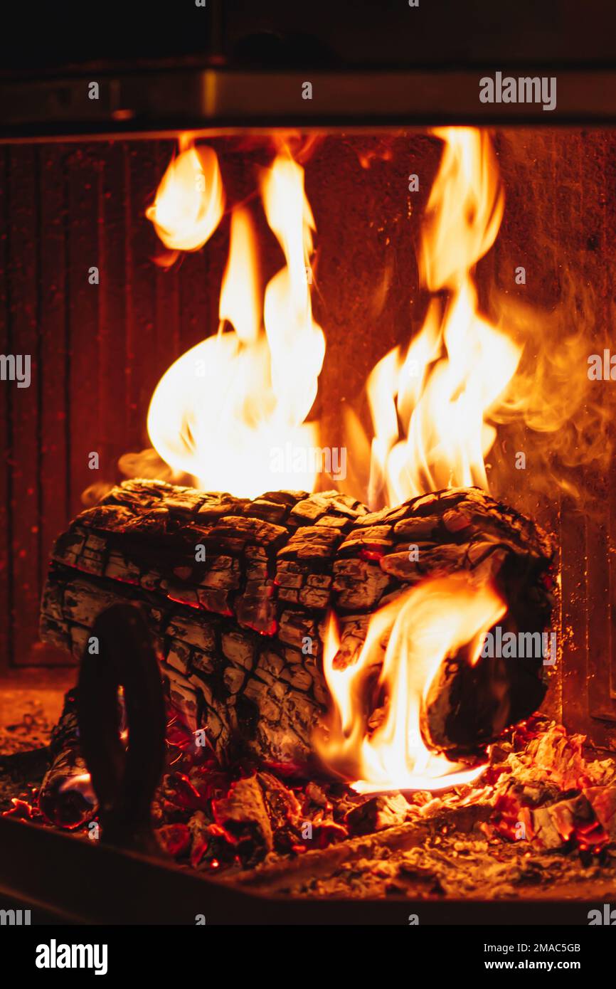 Log of wood burning in a fireplace inside a house, hearth Stock Photo ...