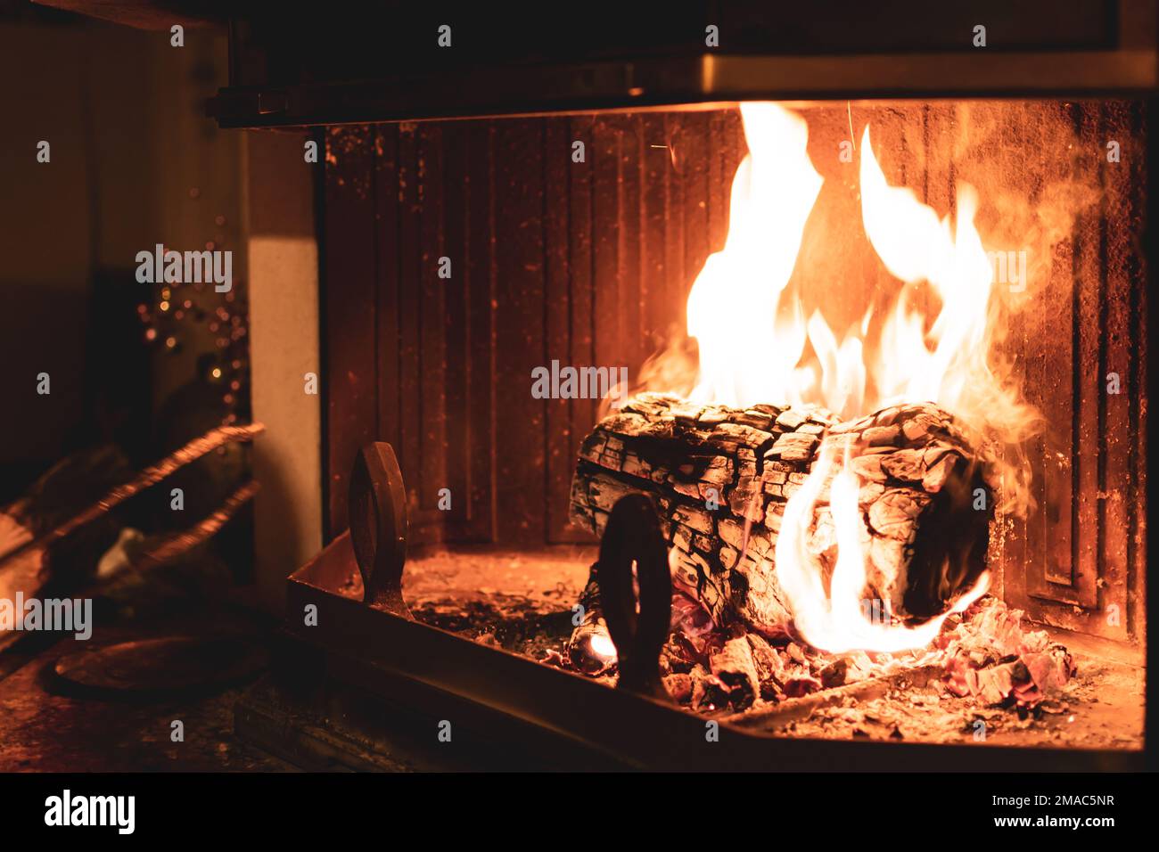 Log of wood burning in a fireplace inside a house, hearth Stock Photo ...