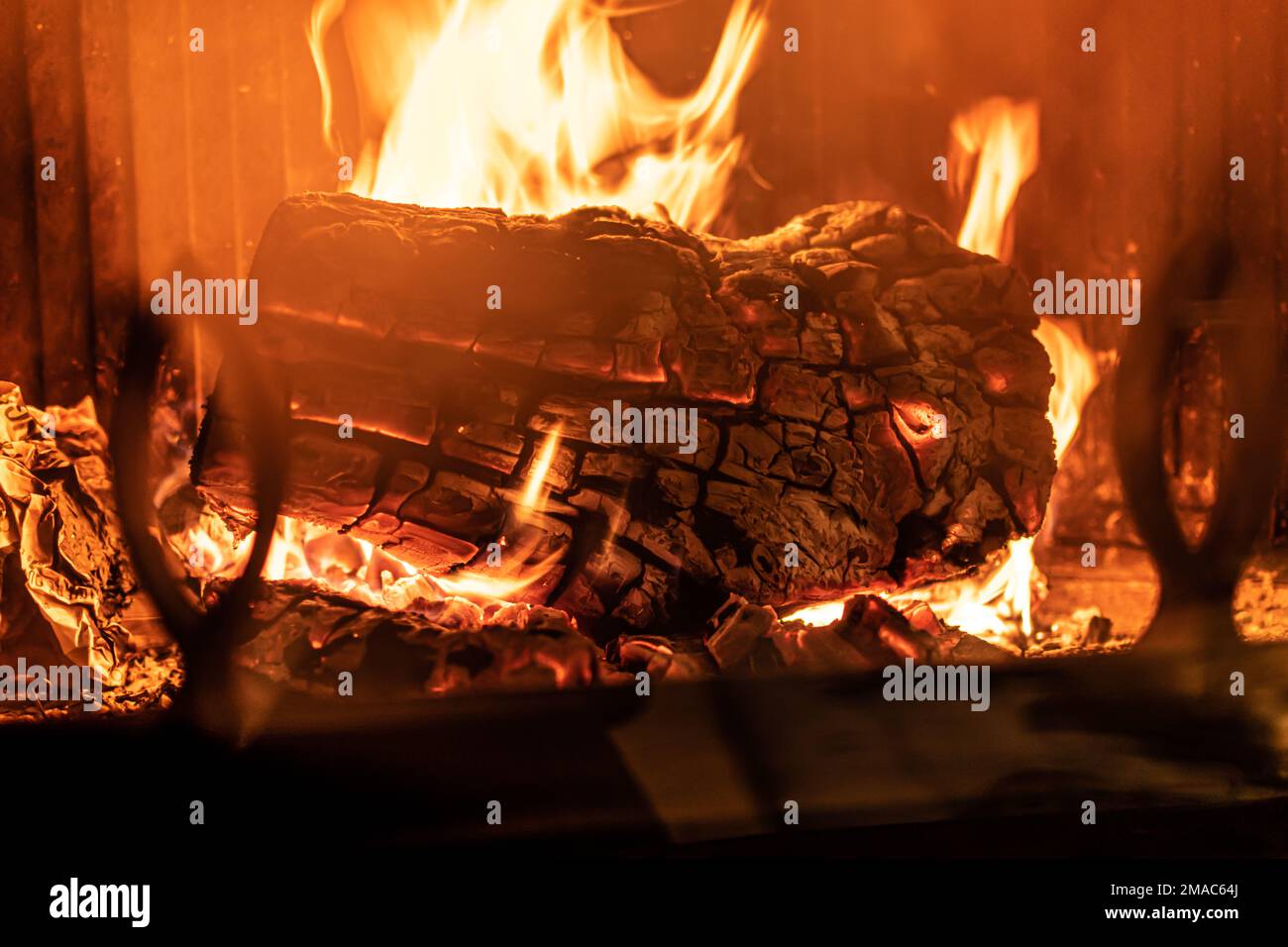 Log of wood burning in a fireplace inside a house, hearth Stock Photo ...