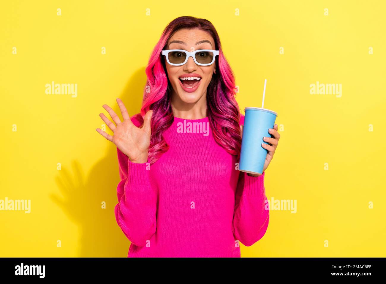 Portrait of astonished positive person raise arm palm hold drink cup ...